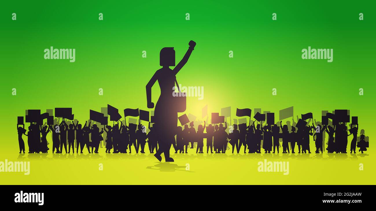 silhouette of woman raising hand over crowd protesters holding protest ...