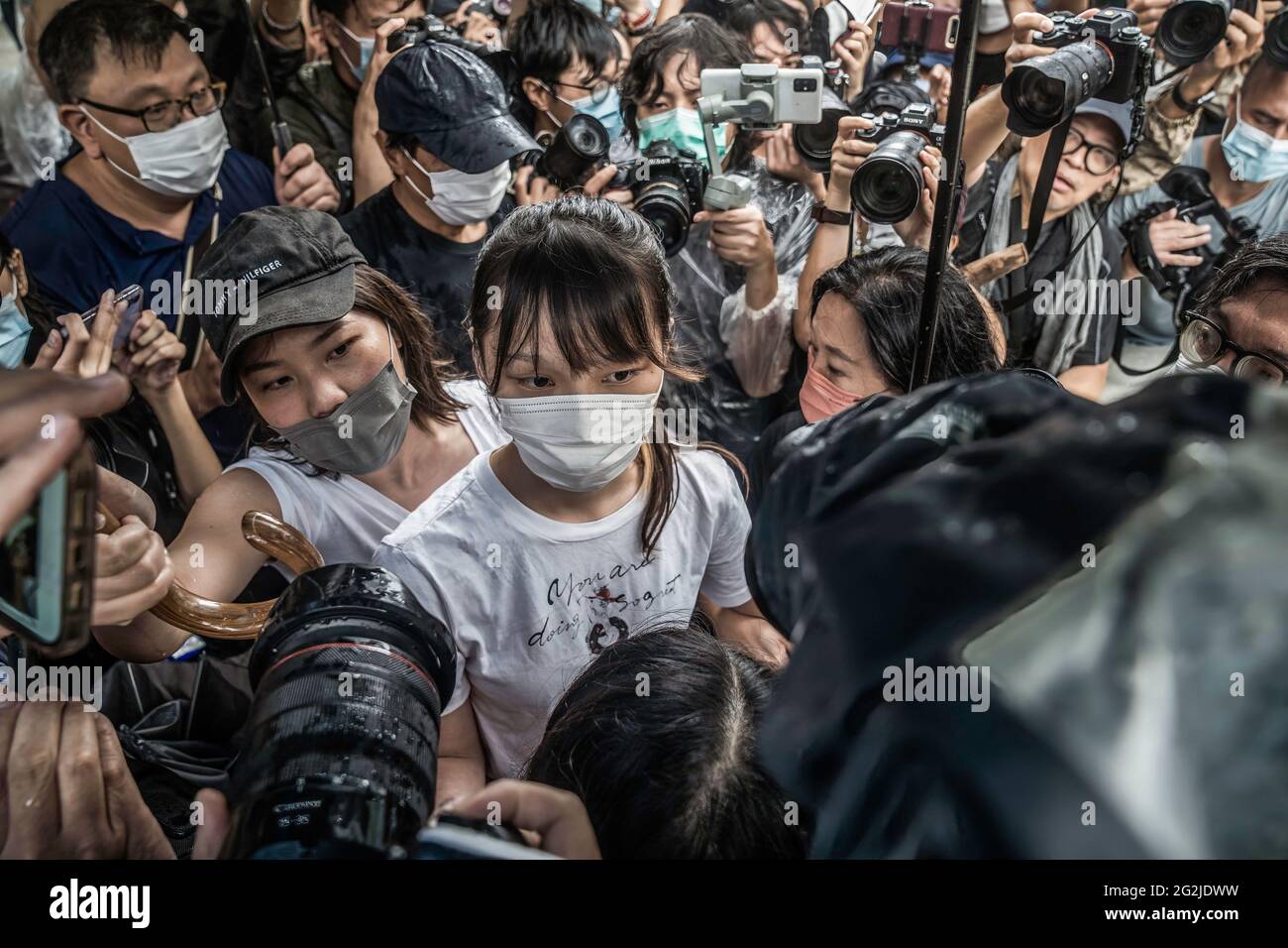 Agnes Chow (C) walks through the media pack after being released from ...