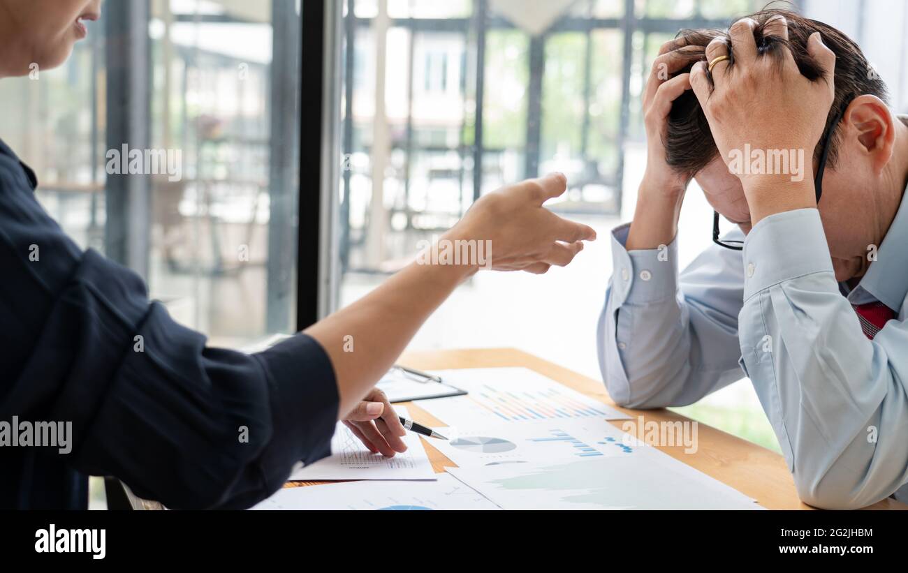 A angry female boss blaming a stressful man about errors on the recent ...