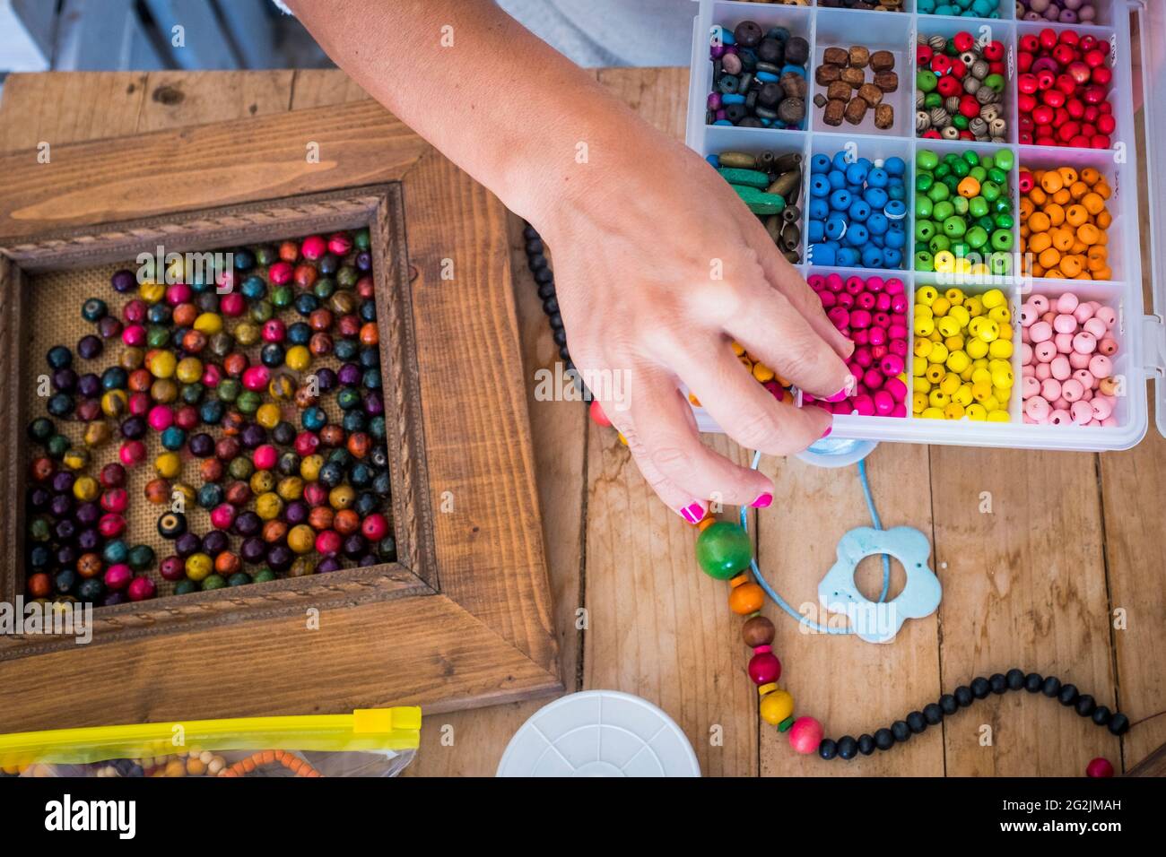 hand made creations jewels - Top view of woman doing jewelry beads ...