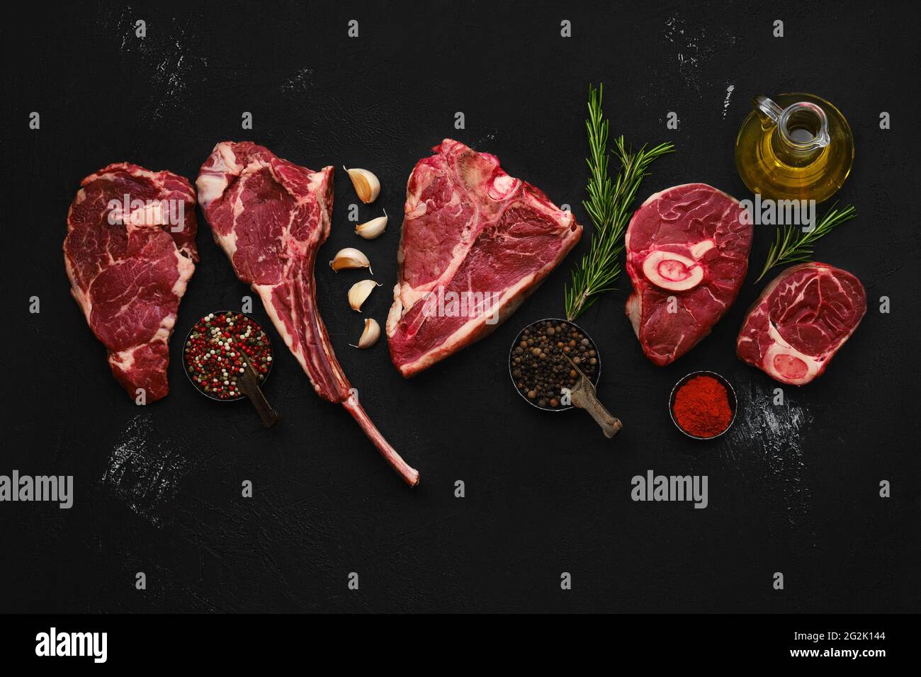 Overhead composition with raw prime beef cuts - porter house, cowboy ...