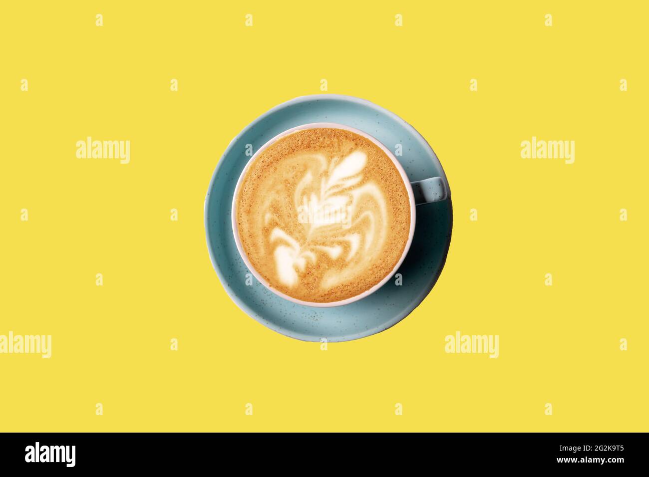 Flat lay latte art coffee with foam in a cup on yellow background, copy ...