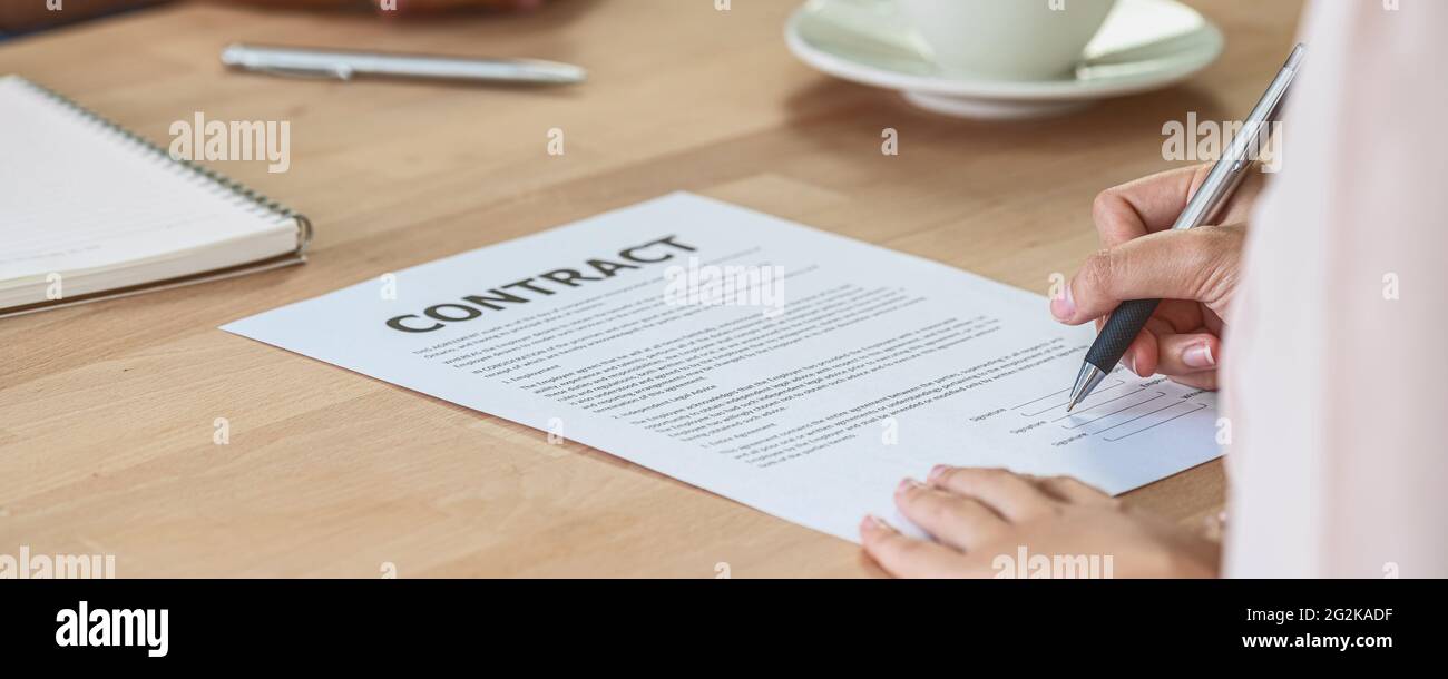 Banner of Closeup Young Asian woman graduate hand signing the contract ...