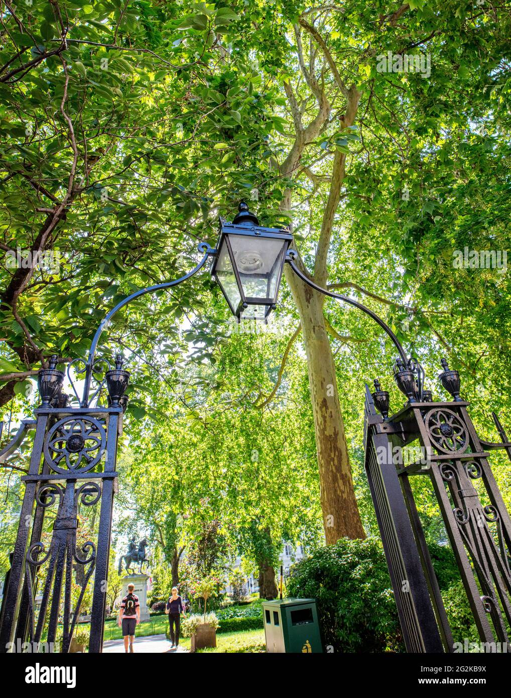 Entrance gates to the garden of St James's Square, London in summer ...