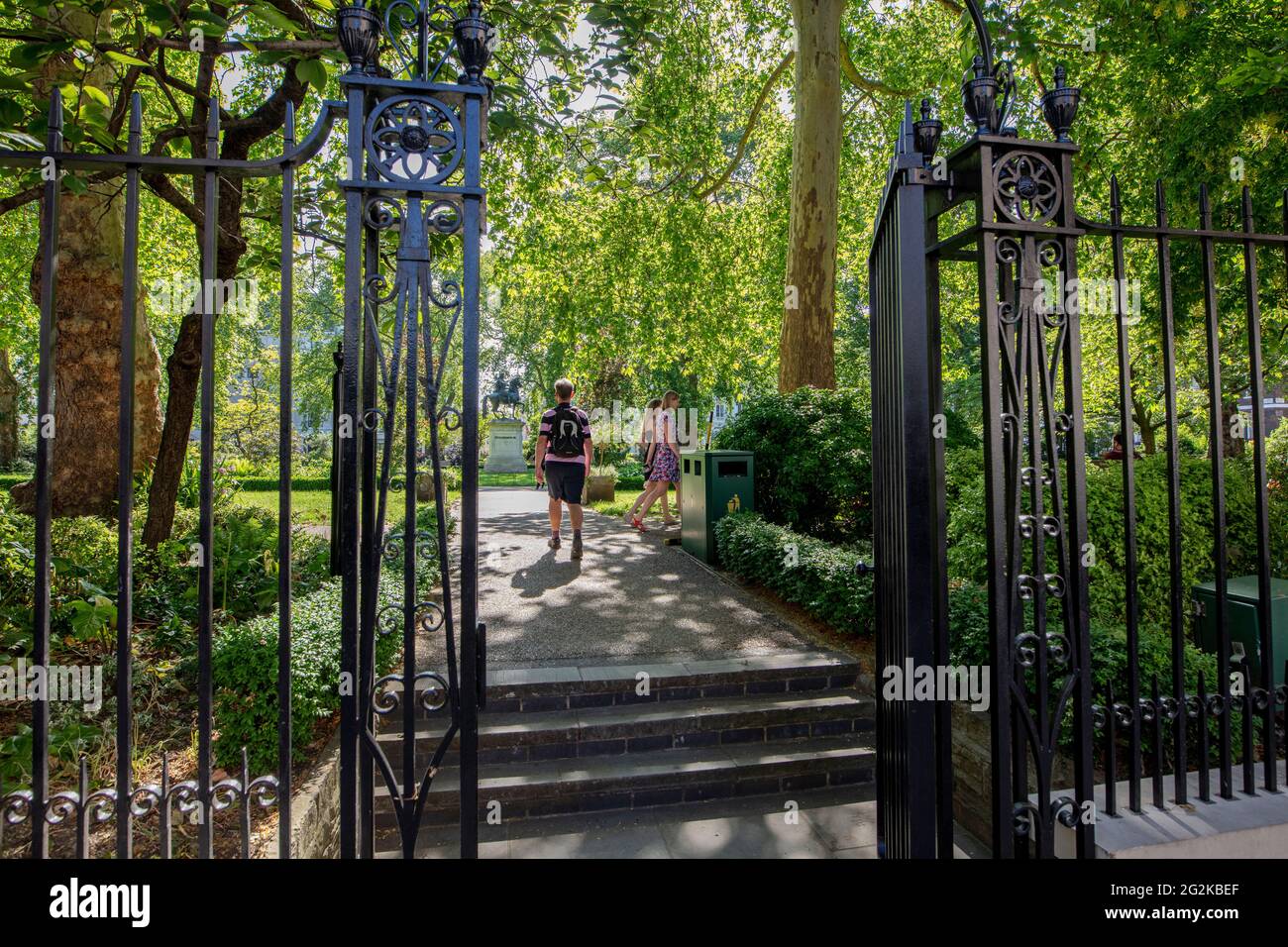 Entrance gates to the garden of St James's Square, London in summer ...