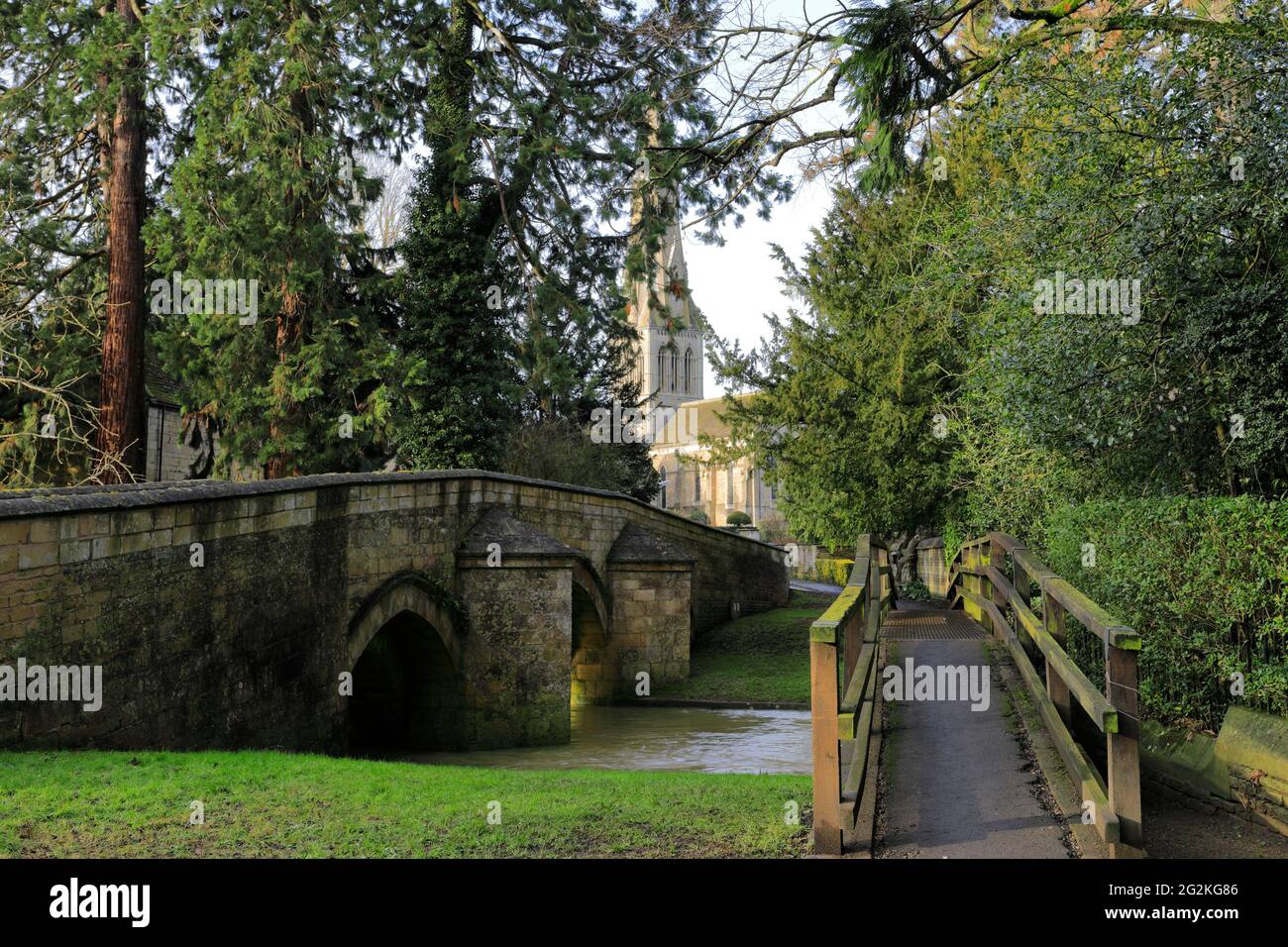 Stone bridge over the river Chater, St Marys church, Ketton village ...