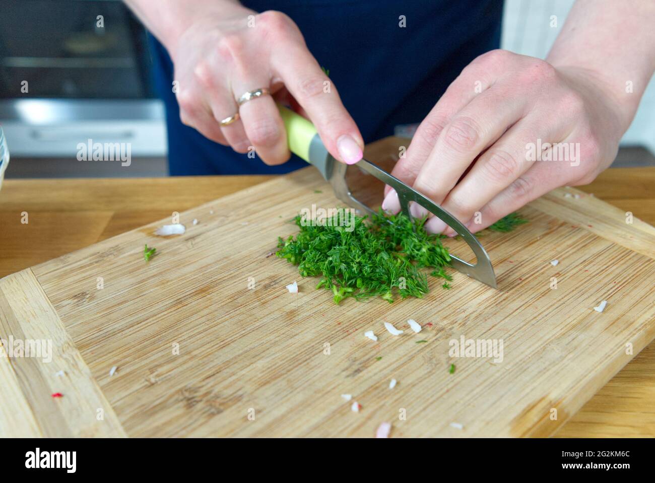 process of cutting dill to prepare food on the wooden board Stock Photo ...
