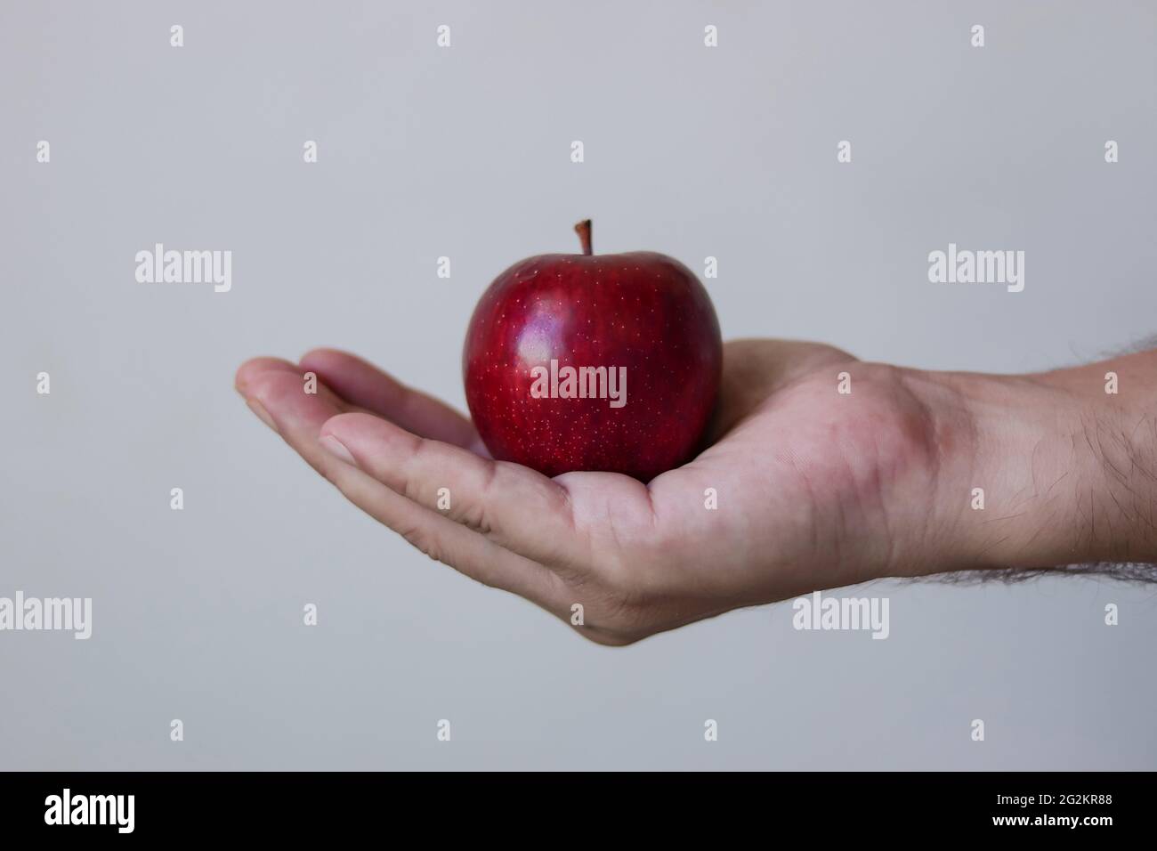 Hand holding apple, fruit hi-res stock photography and images - Alamy