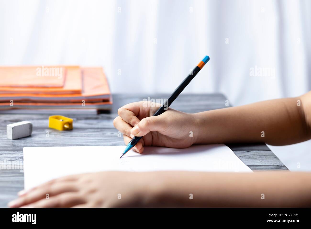Child writing with pencil hi-res stock photography and images - Alamy