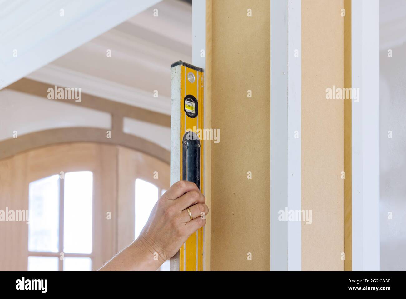 Worker using leveling instrument check appropriate wood columns using ...