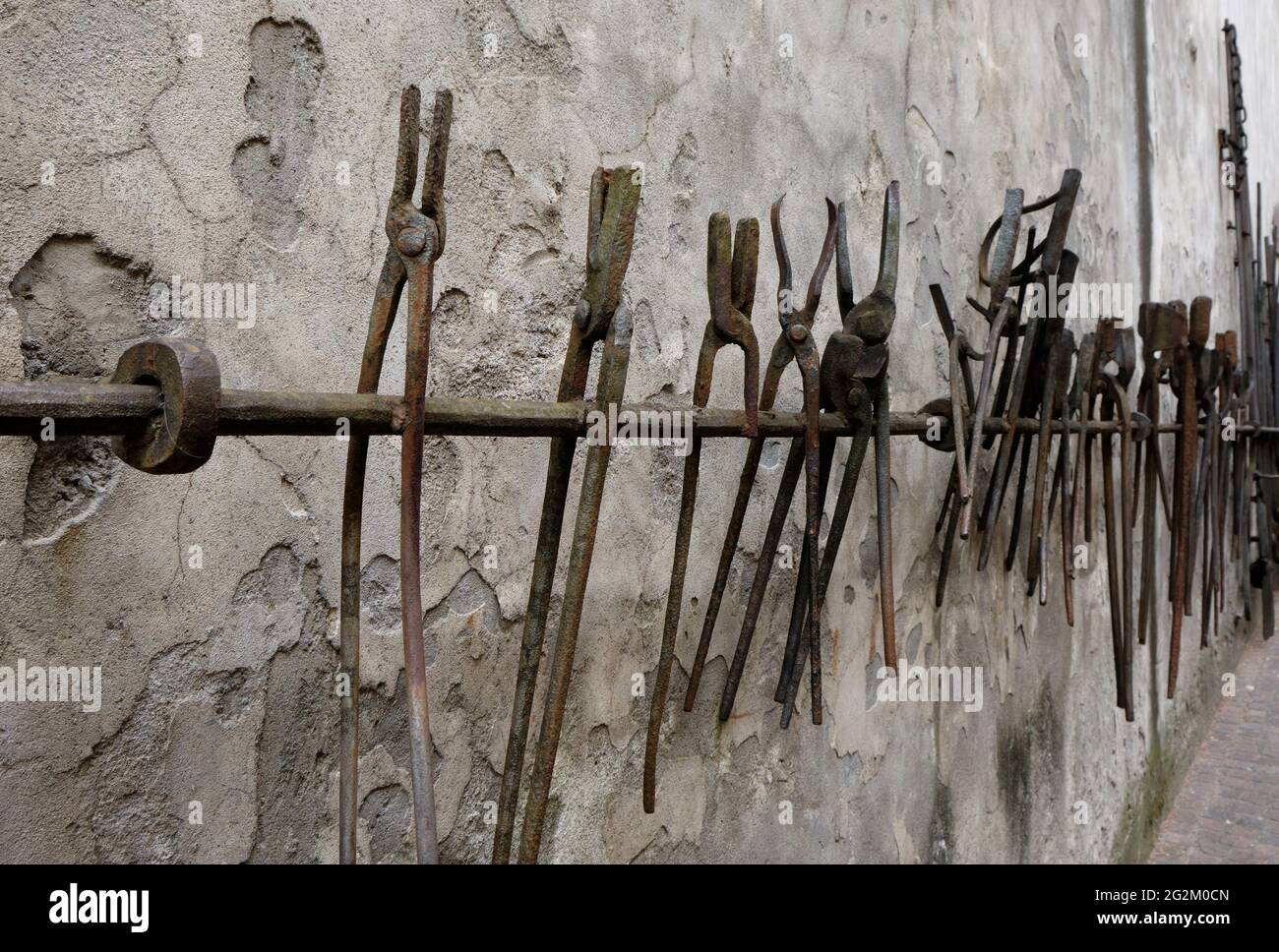 decorated facade with old agricultural tools in the small old village ...