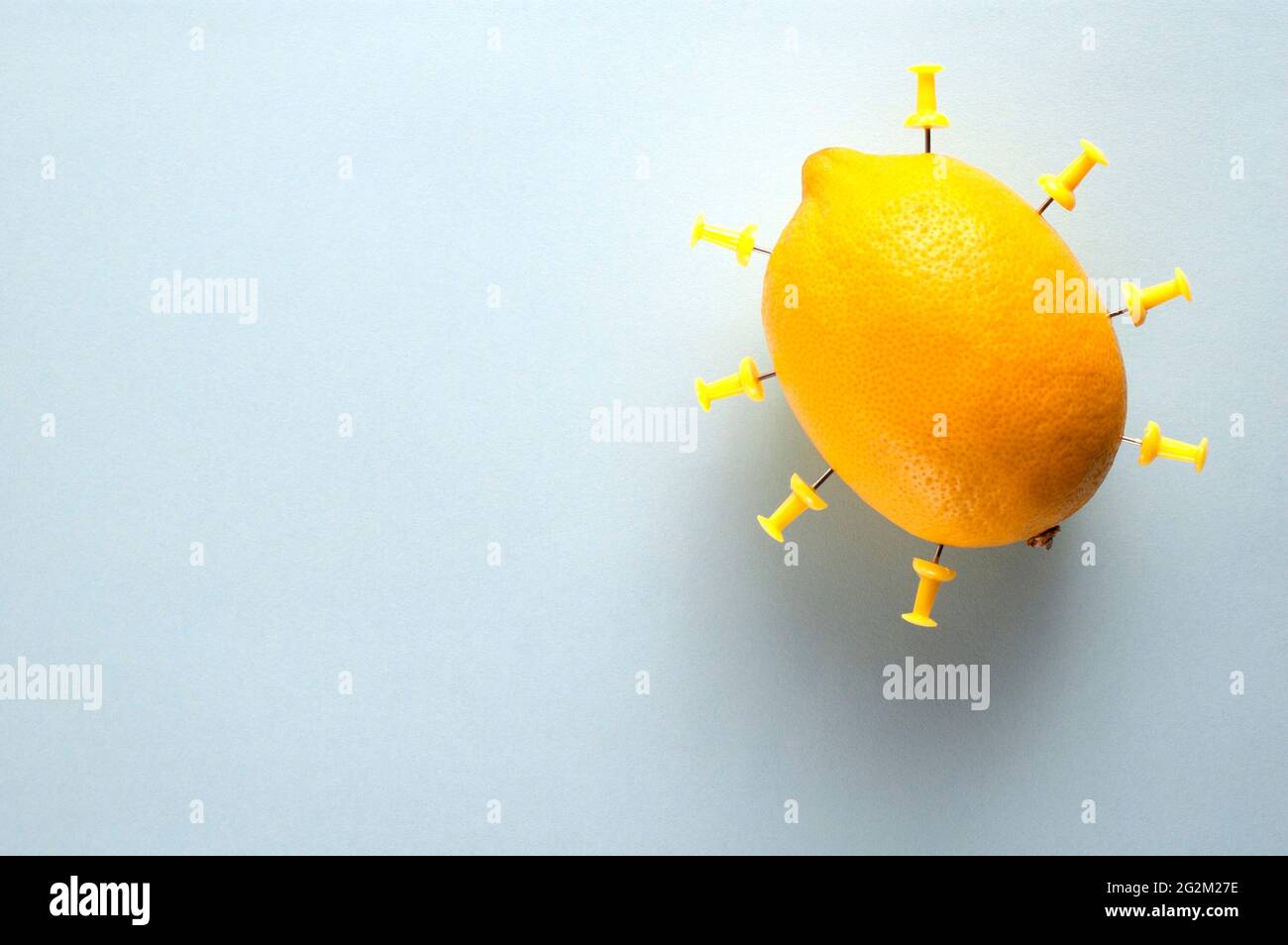 A simple creative object made of lemon and paper pins Stock Photo - Alamy