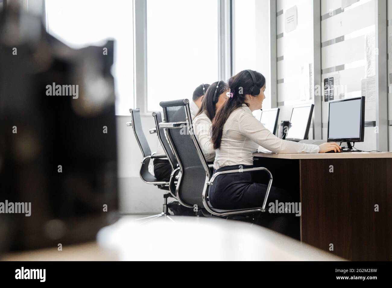 call center workers in the office at work on the computer Stock Photo ...