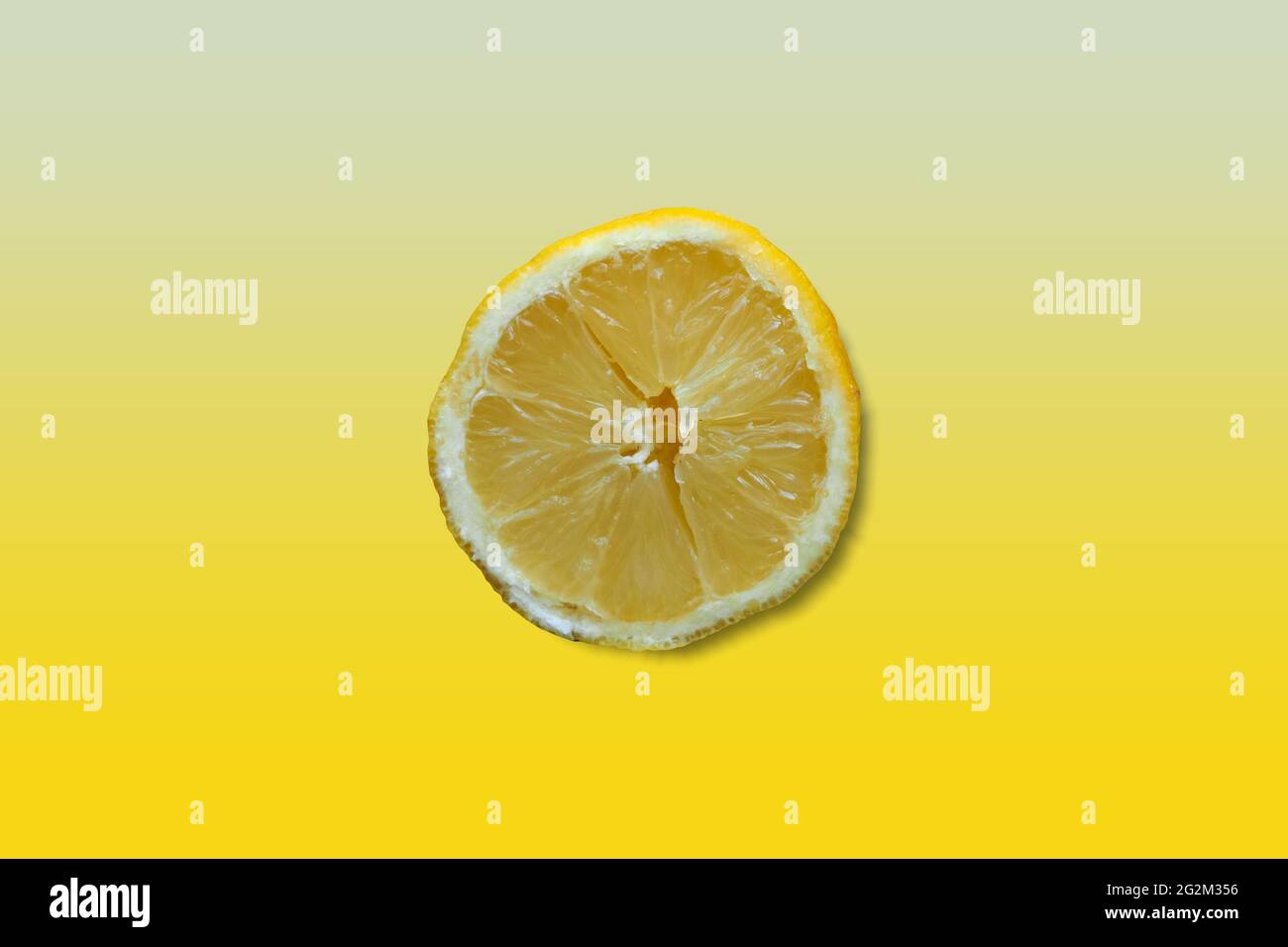 yellow lemon slice over matching colour gradient background with copy ...