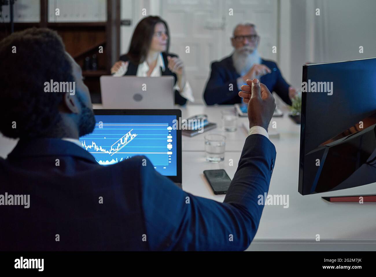 Anonymous black worker interacting with partners during meeting in ...