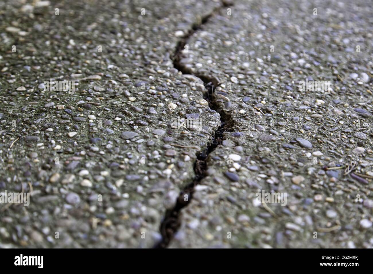 Detail of crack and break in a road Stock Photo - Alamy