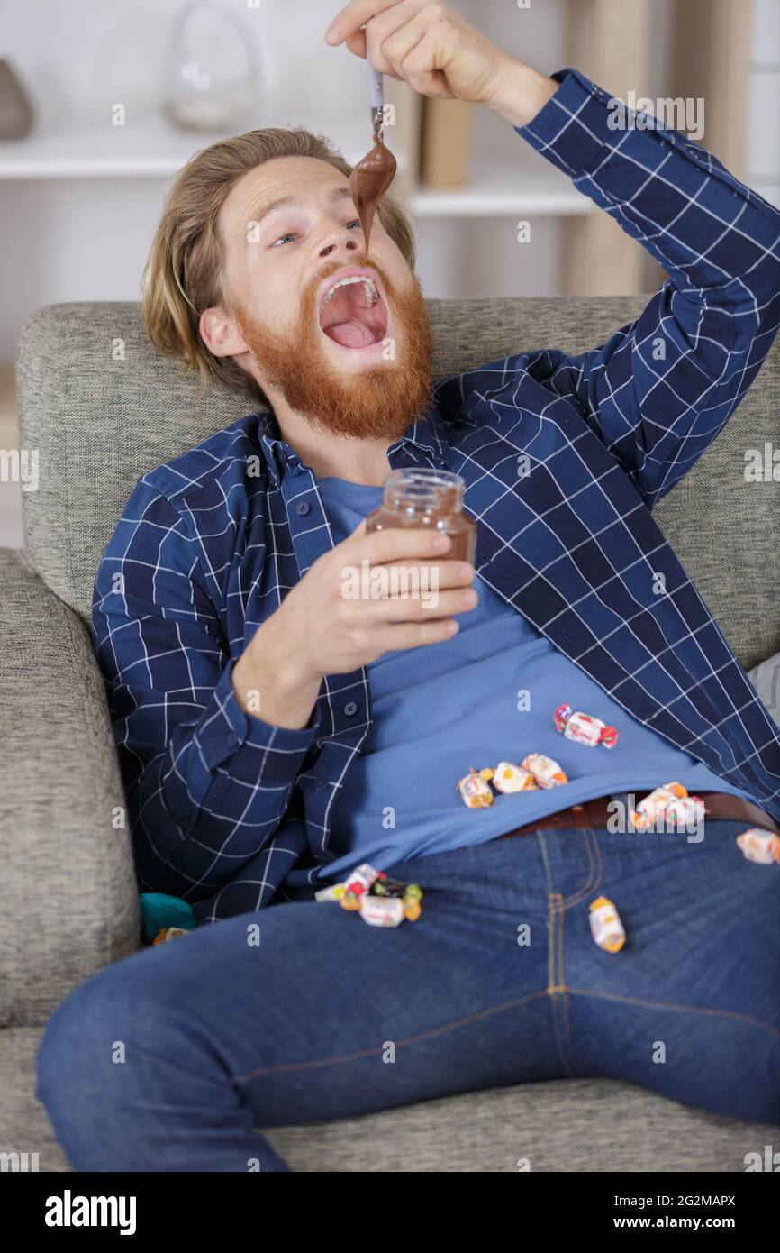 Lazy man couch eating hi-res stock photography and images - Alamy