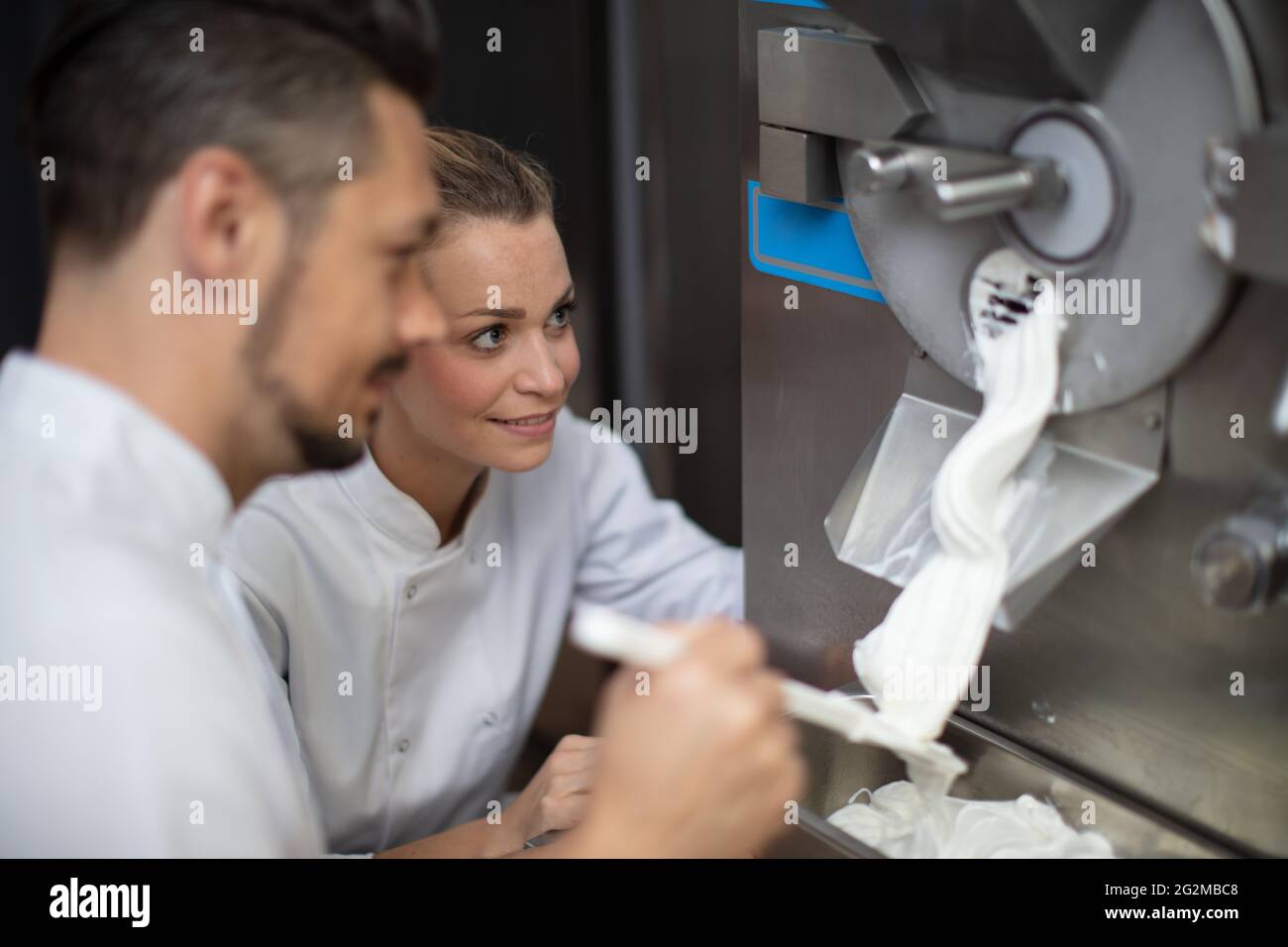 workers looking at the ice cream machine Stock Photo - Alamy