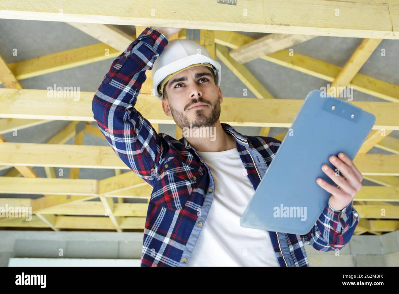 building inspector checking roof beam from the interior Stock Photo - Alamy