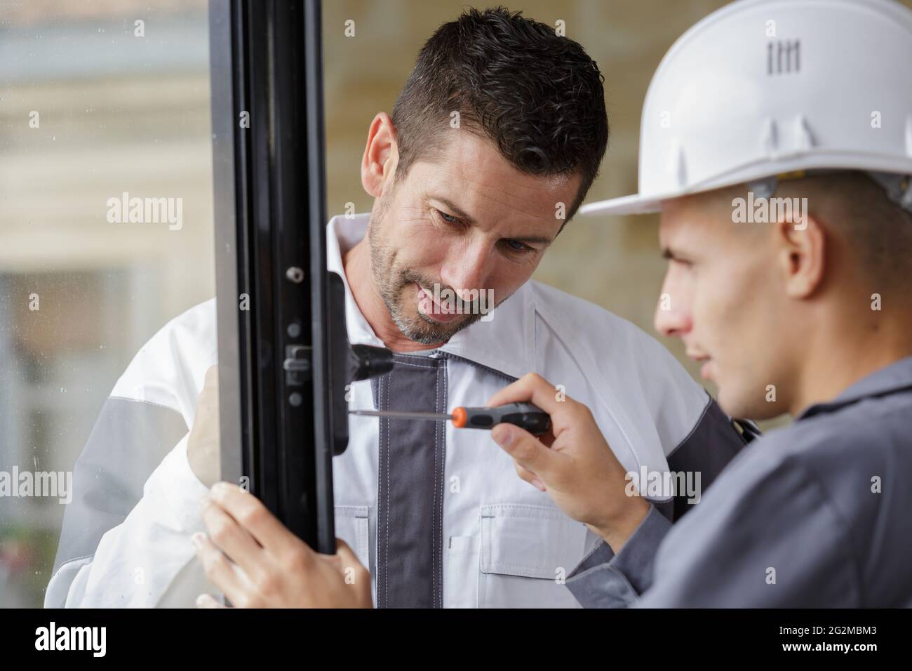 window and door glazing installer apprentice Stock Photo - Alamy