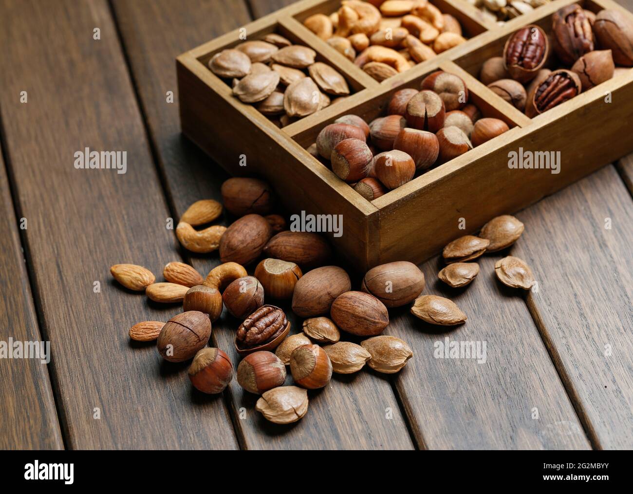 Various nuts in wooden box Stock Photo - Alamy