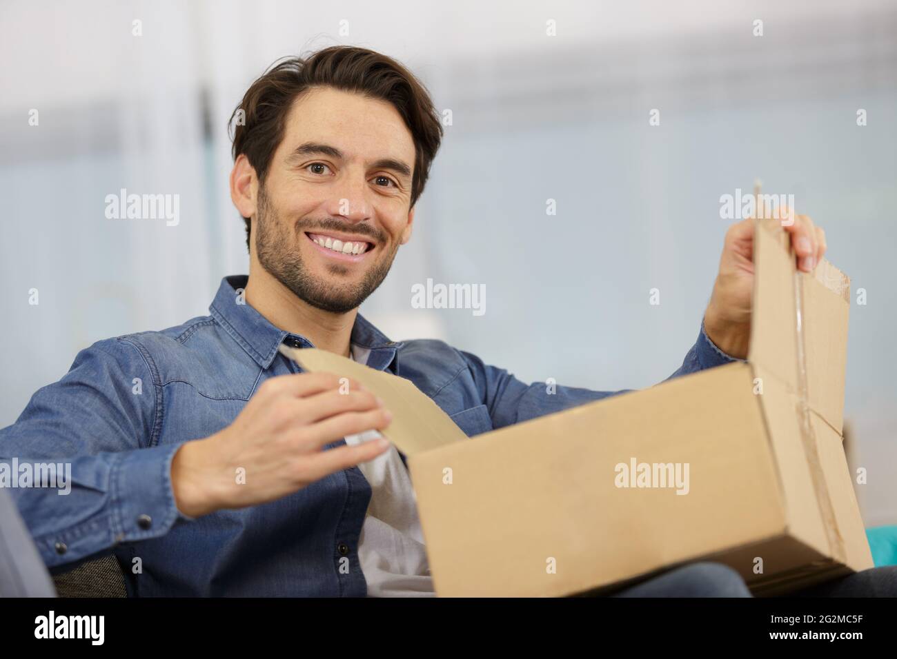 picture of a man opening a box Stock Photo - Alamy