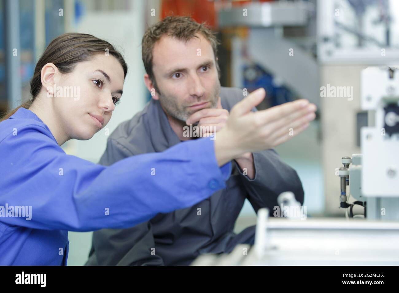 factory workers checking goods on production line Stock Photo - Alamy