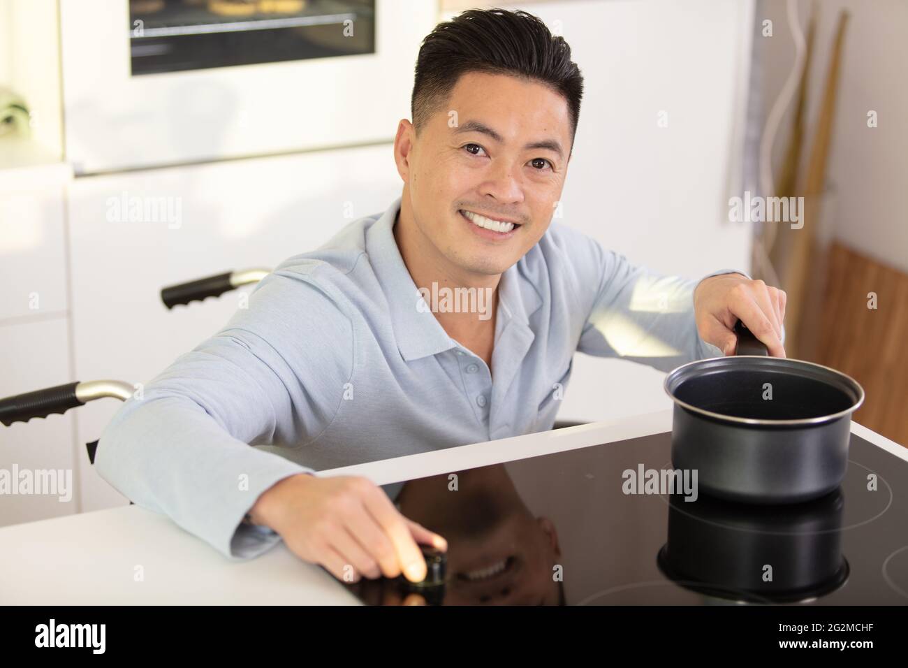 happy disabled asian man preparing food in the kitchen Stock Photo - Alamy