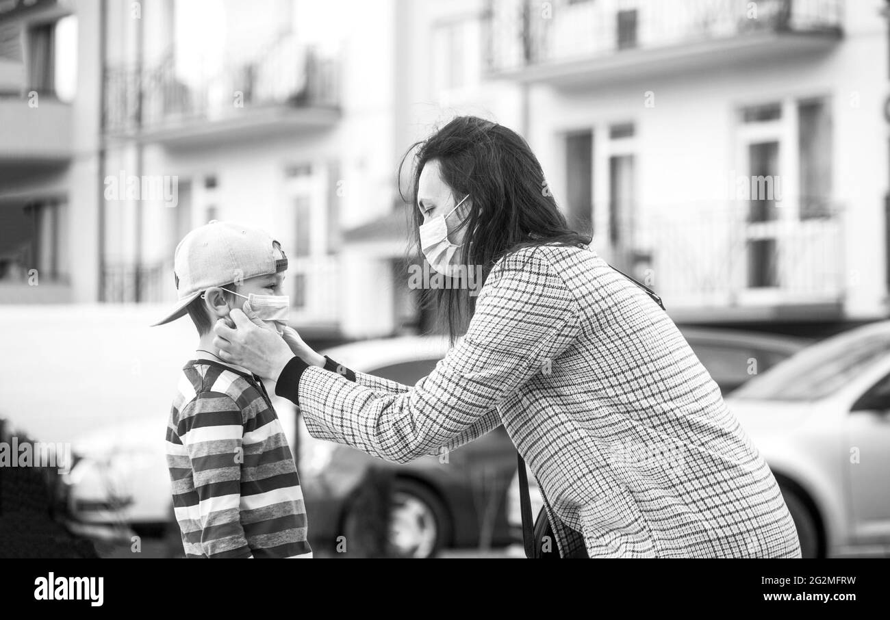 Mother, child wear facemask during coronavirus, flu outbreak. Mom with ...