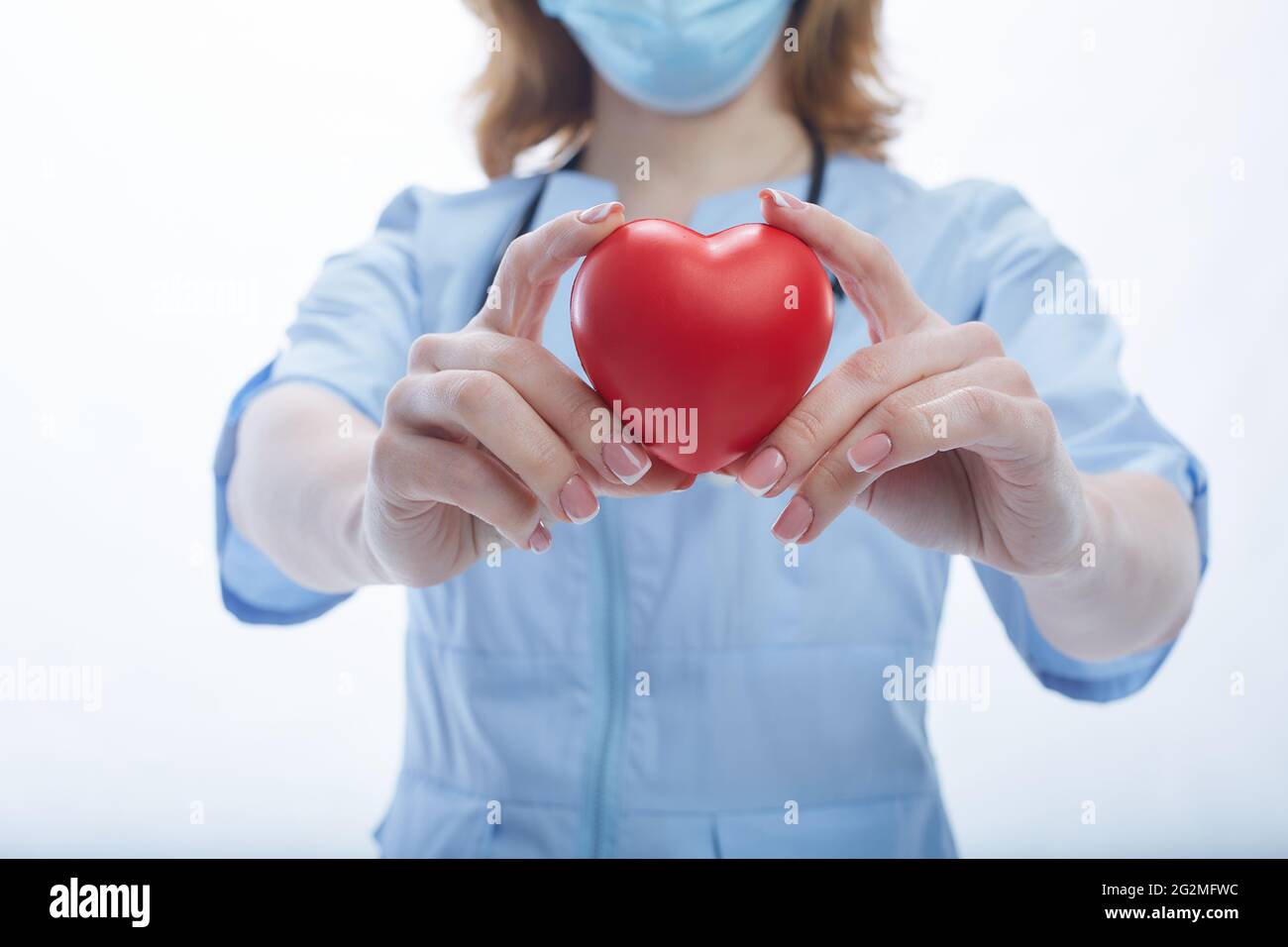 Female doctor hands holding the heart. Red heart showing by woman ...