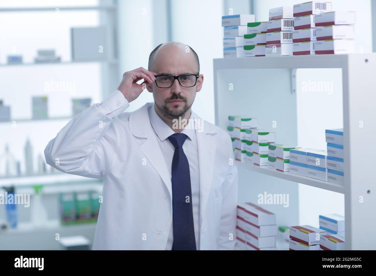 Pharmacist is working. Man wearing special uniform located in pharmacy ...