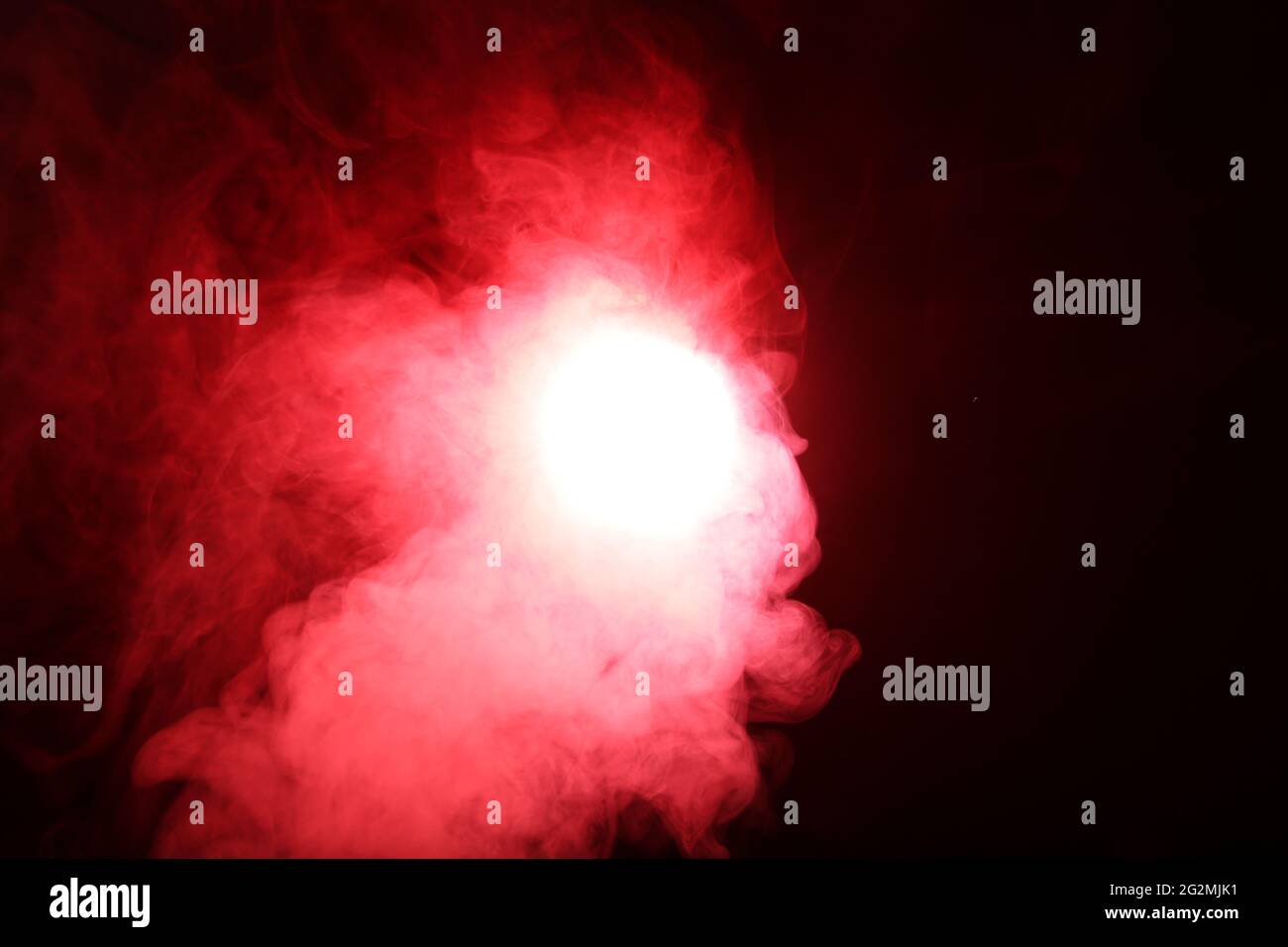 Smoke in red light on black background Stock Photo - Alamy