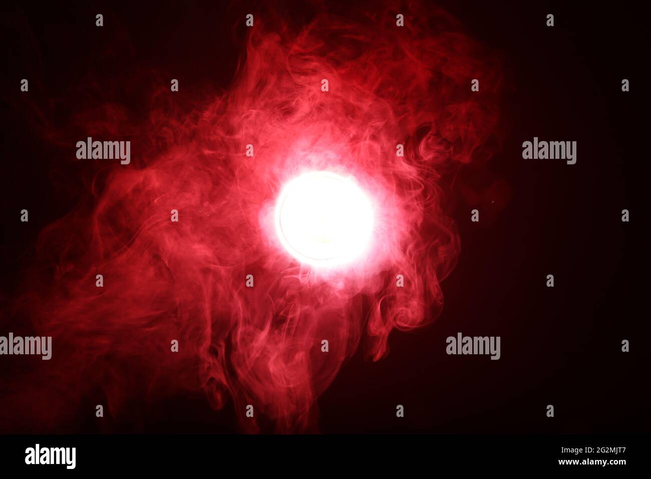 Smoke in red light on black background Stock Photo - Alamy