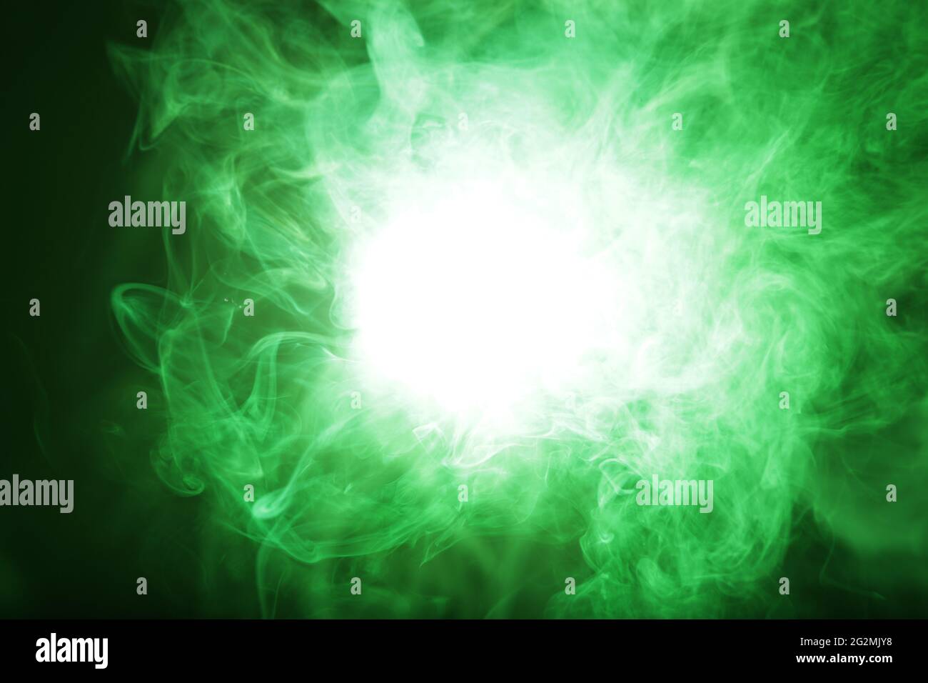 Smoke in green light on black background Stock Photo - Alamy