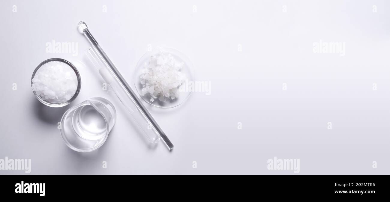 Crystal clear liquid in beaker, Microcrystalline wax in glass container ...