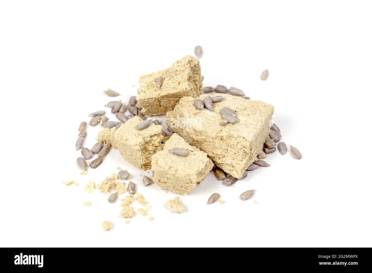 Traditional sweet turkish delight halva pieces with sunflower seeds isolated on white background ...
