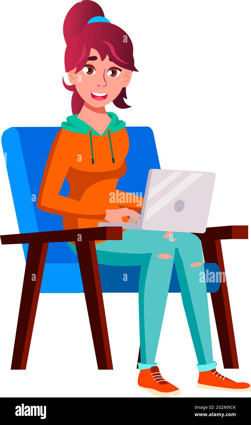 european girl sitting on armchair and watches videos on notebook ...