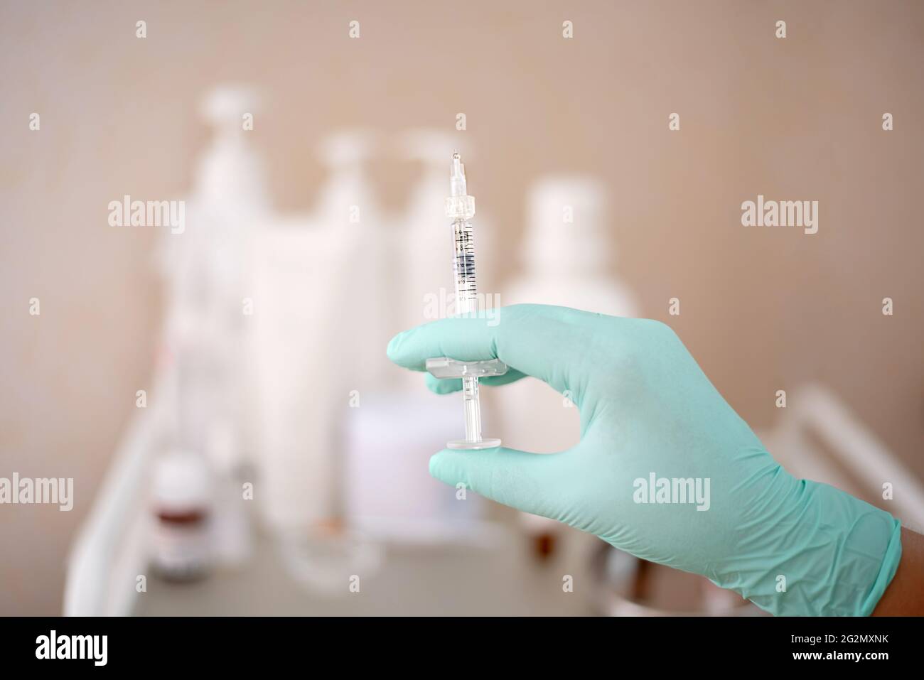 Syringe with cosmetology injection in the hand of the beautician ...