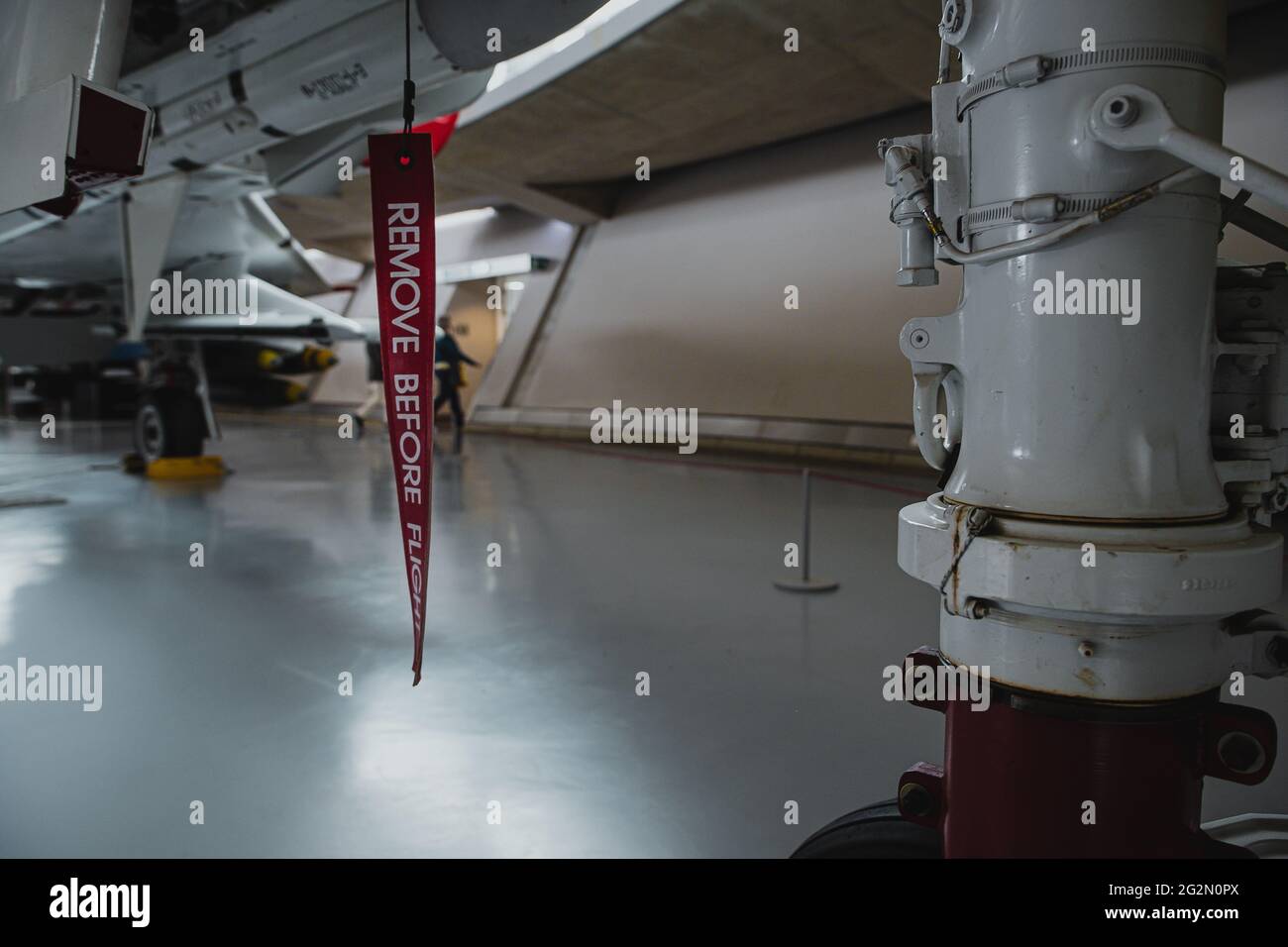 Red ribbon stating Remove Before Flight, attached to a fighter jet as a ...
