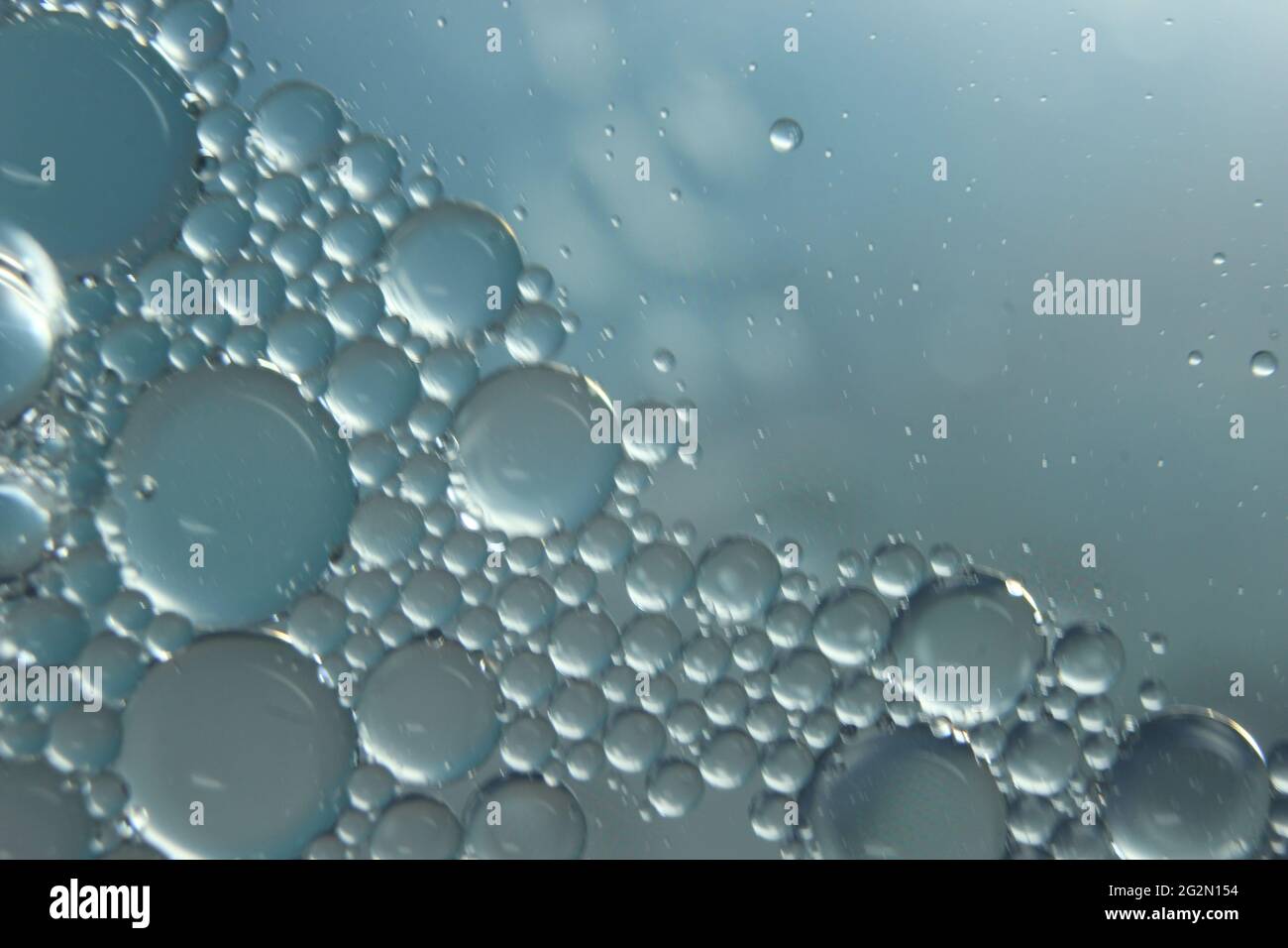 Abstract macro background of oil bubbles floating over water surface ...