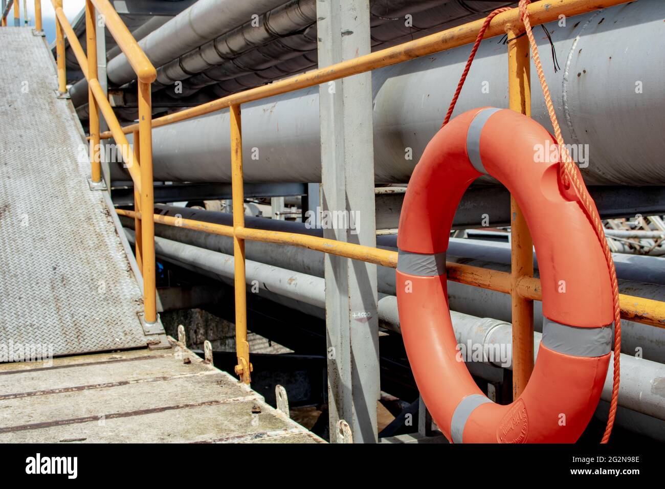 Life Buoys attached to and suspended on the fence of the seafront ...