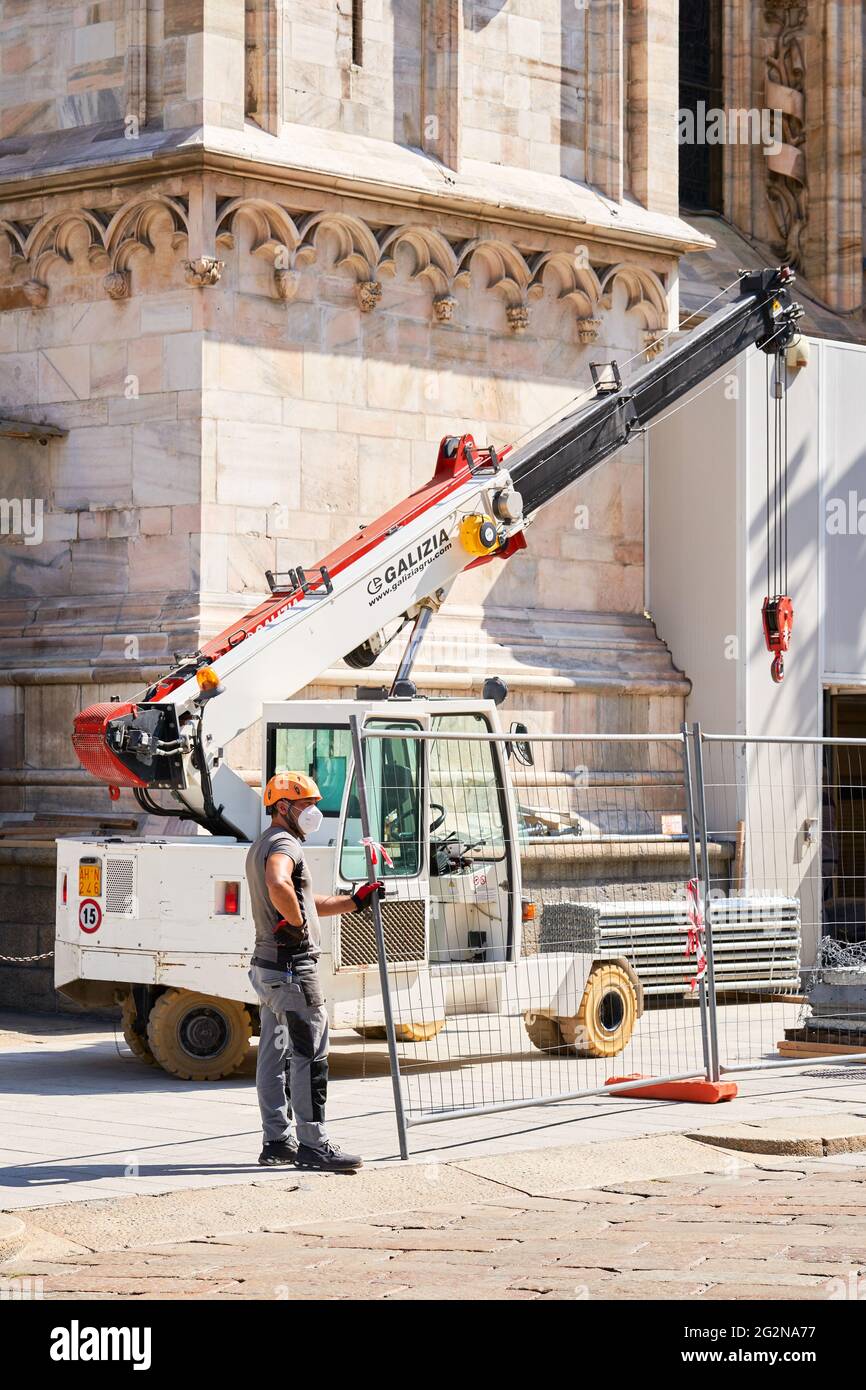 Milan, Italy - July 7, 2020. Construction worker on duty standing close ...