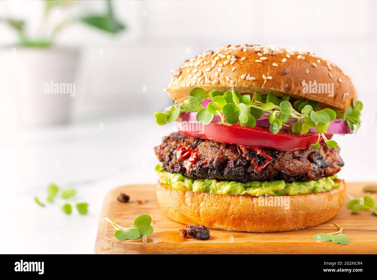 Healthy, plant based black bean burger with avocado and microgreens ...