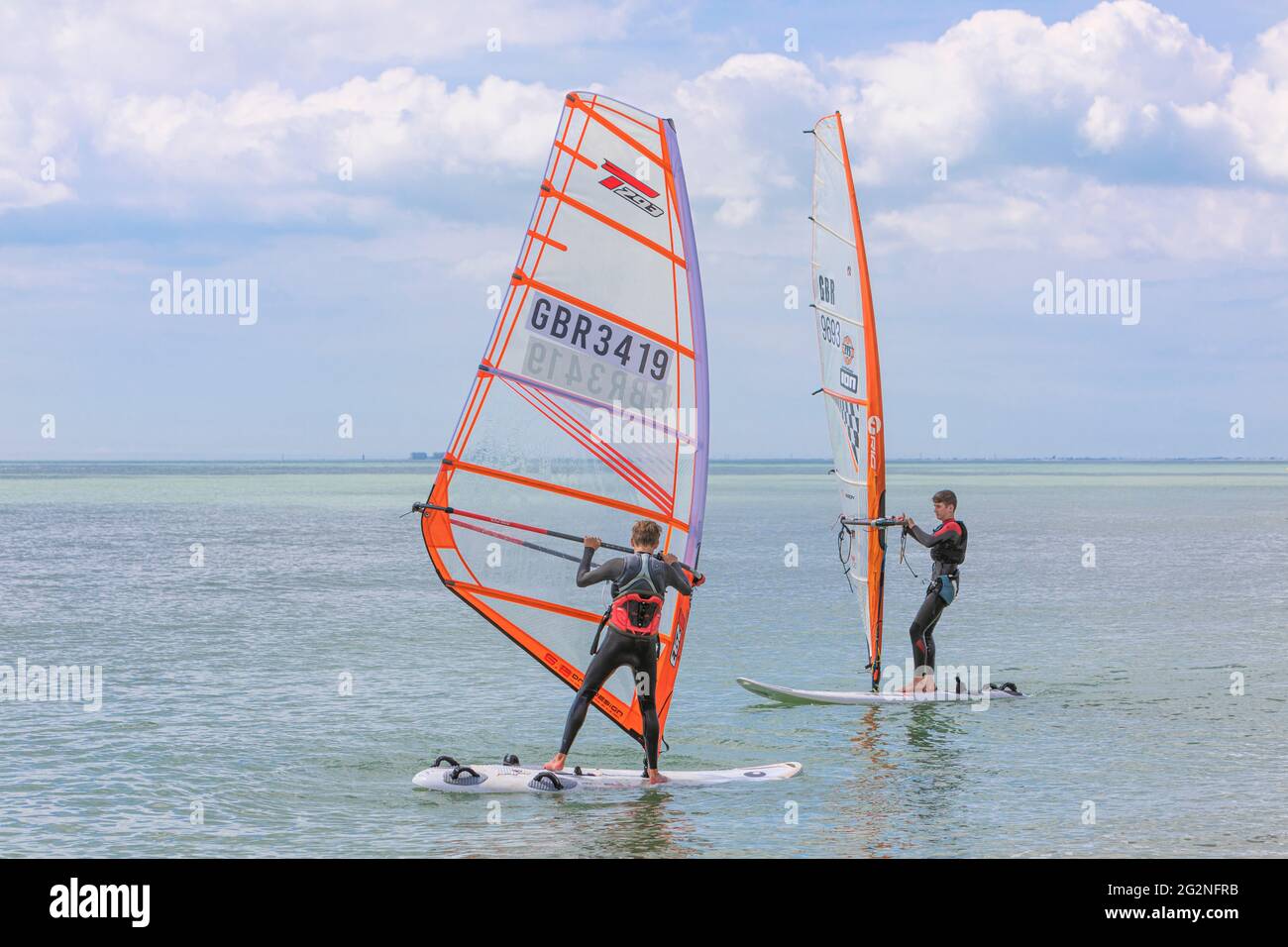 Two wind surfers just off the beach in Hythe, Kent Stock Photo - Alamy