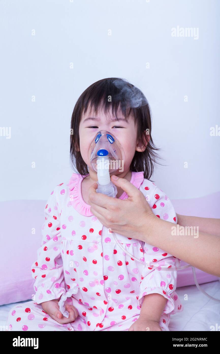 Doctor helps little asian (thai) girl taking respiratory (child was ...