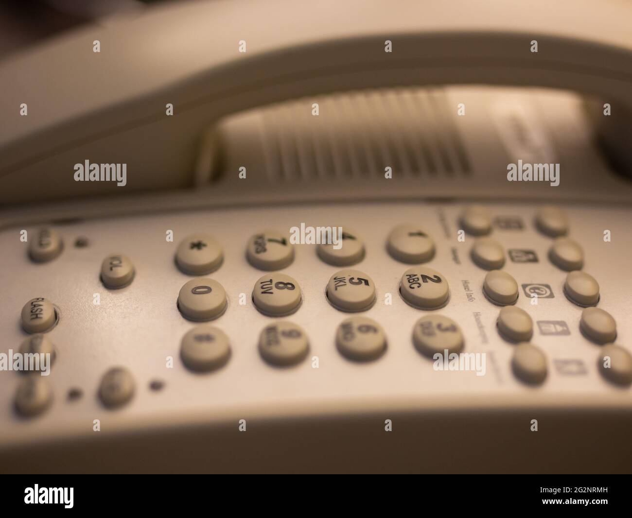 close up soft focus on telephone devices at hotel desk with yellow ...