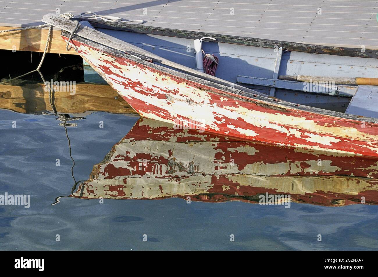 Coastal Cape Cod scene. Colorful reflection of weathered red rowboat ...