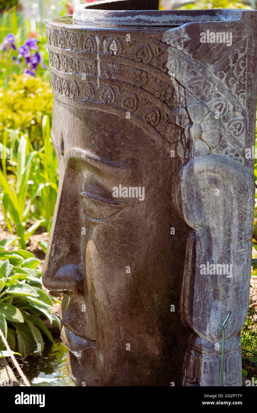 A large head statue used as a water fountain in the popular tourist ...