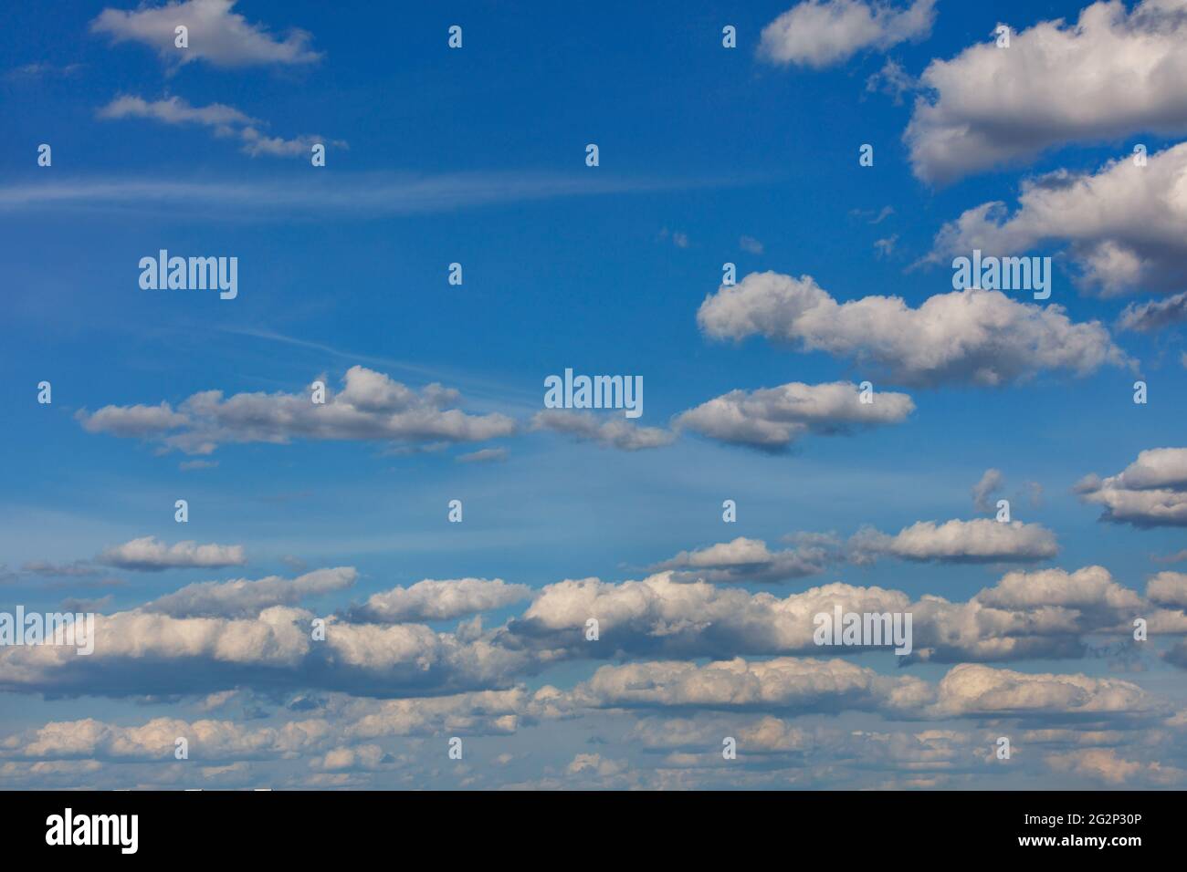 Soft clouds gather in dense clouds and float above, forming windows of ...