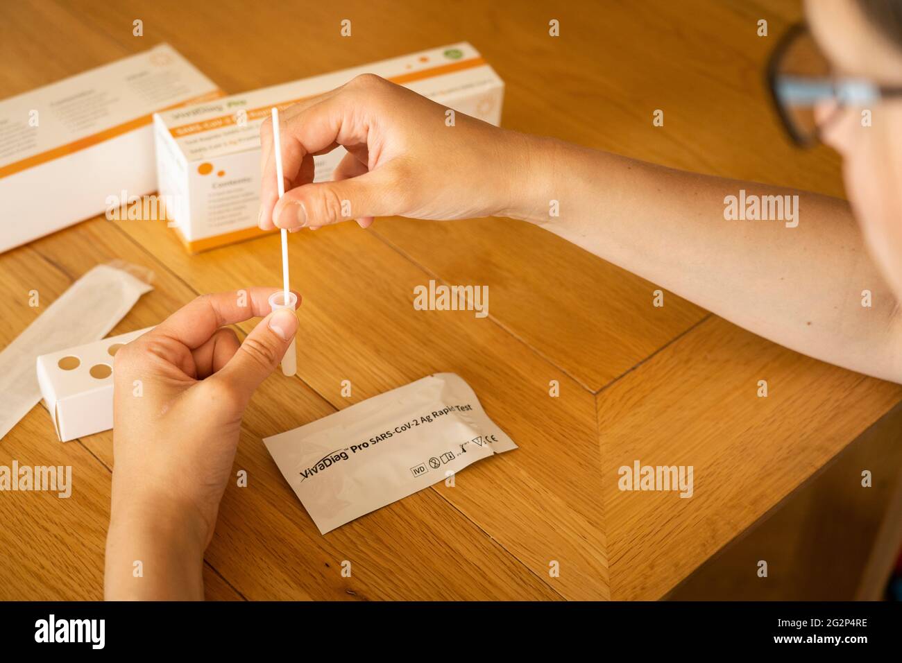 A woman taking a self diagnostic VivaDiag SARS-CoV-2 Ag Rapid Test for ...